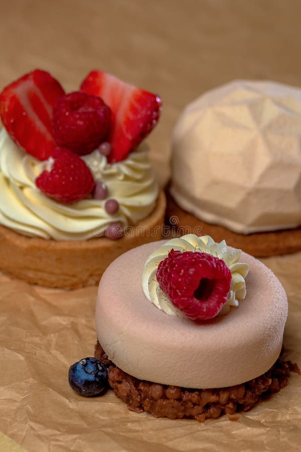 Three Delicious Cakes with Fruit on Brown Paper, Large Photo Stock ...