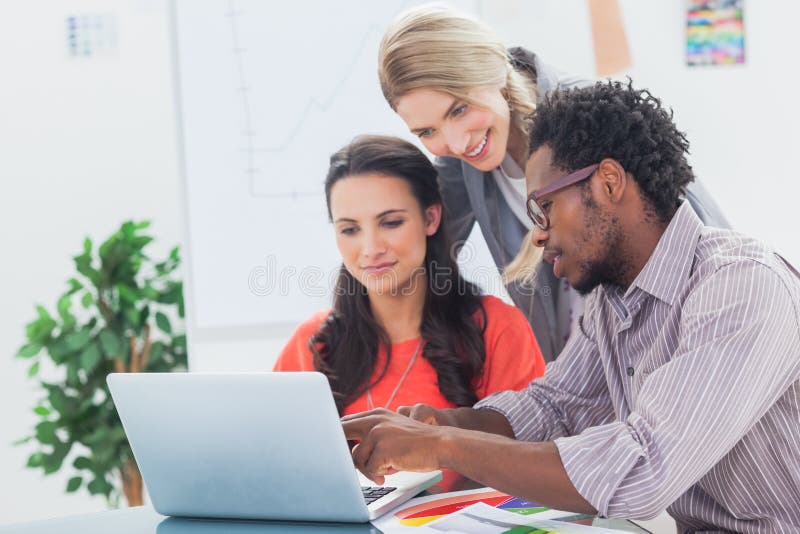 Three Designers Working Together on a Laptop Stock Image - Image of ...