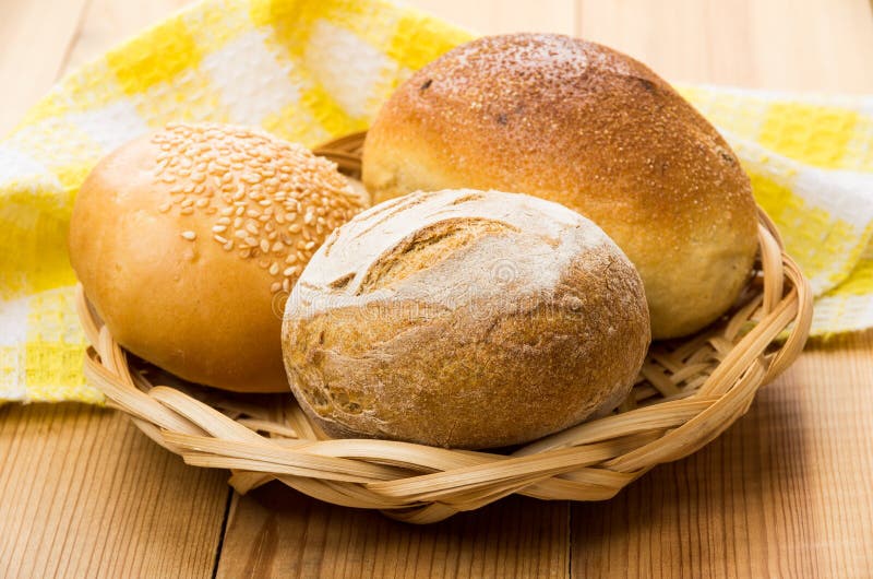 Three Different Buns in Wicker Basket on Table Stock Photo - Image of ...