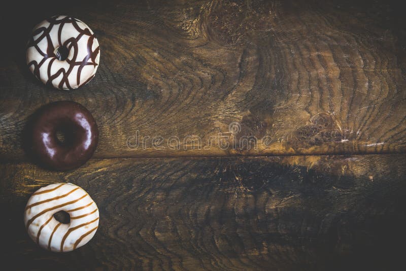 Three Different Chocolate Donuts on Rustic Dark Wood Stock Image ...