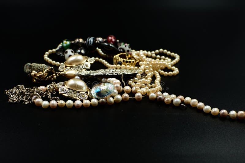 Three Different Colored Pearl Necklaces and Bracelets on a Table Stock ...