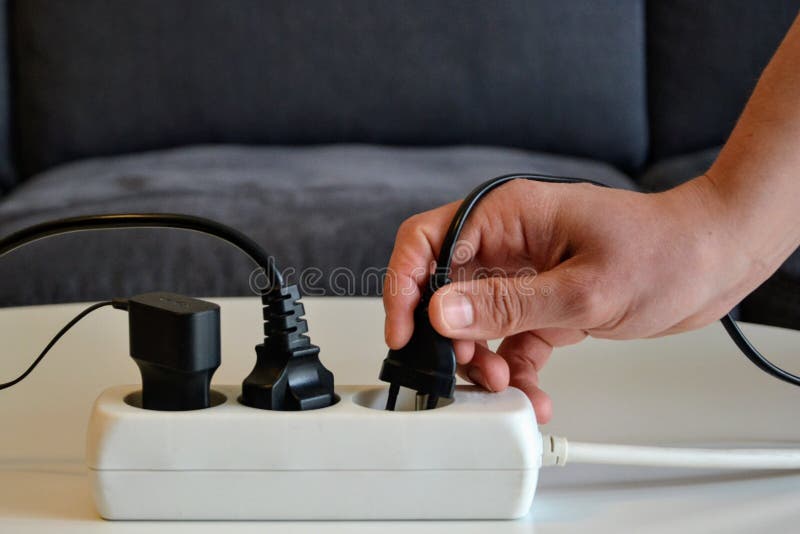 Male Hand Connecting an Electrical Plug To a Power Strip Stock Photo ...