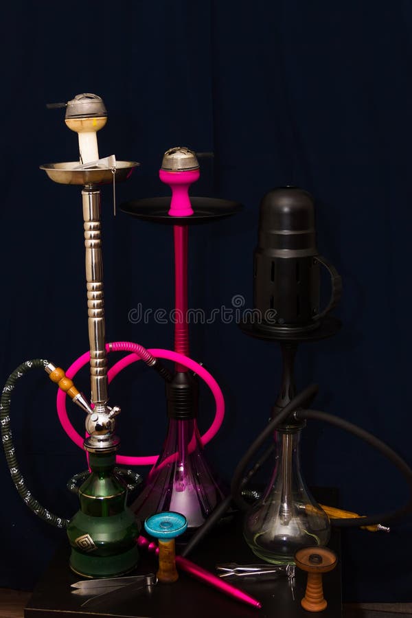 Three Different Hookahs on the Table on a Dark Blue Background Stock ...