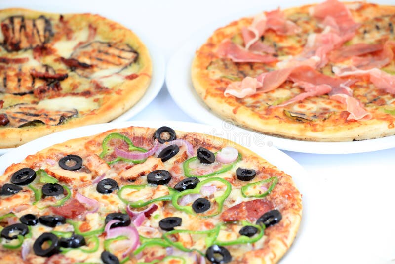 Three Pizzas With Four Kinds Of Cheese Of Different Size On A Dark ...
