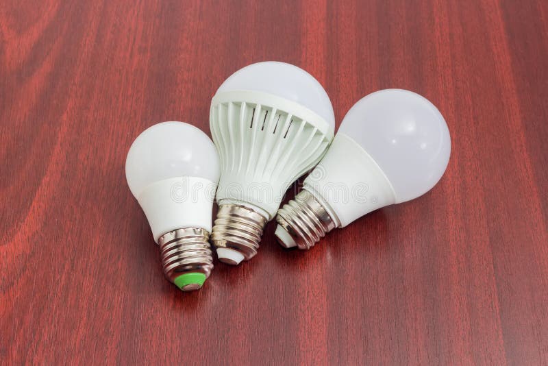 Three Different Light Emitting Diode Lamp on a Wooden Surface Stock ...