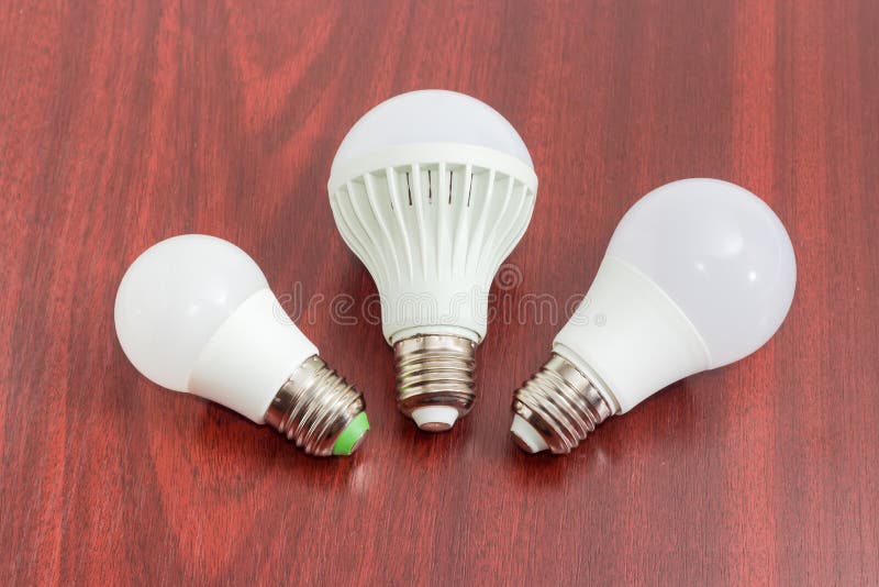Three Different Light Emitting Diode Lamp on a Wooden Surface Stock ...