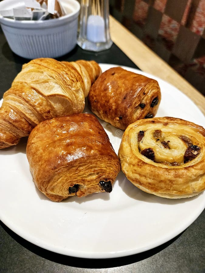 Three Different Pastries on the Plate at the Table with a Bowl of ...