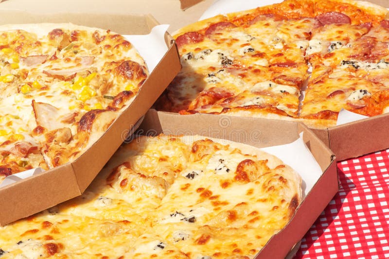 Three Different Pizzas on the Background of a Checkered White and Red ...