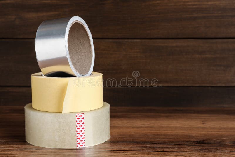 Three Different Rolls of Adhesive Tape on Wooden Table. Space for Text ...