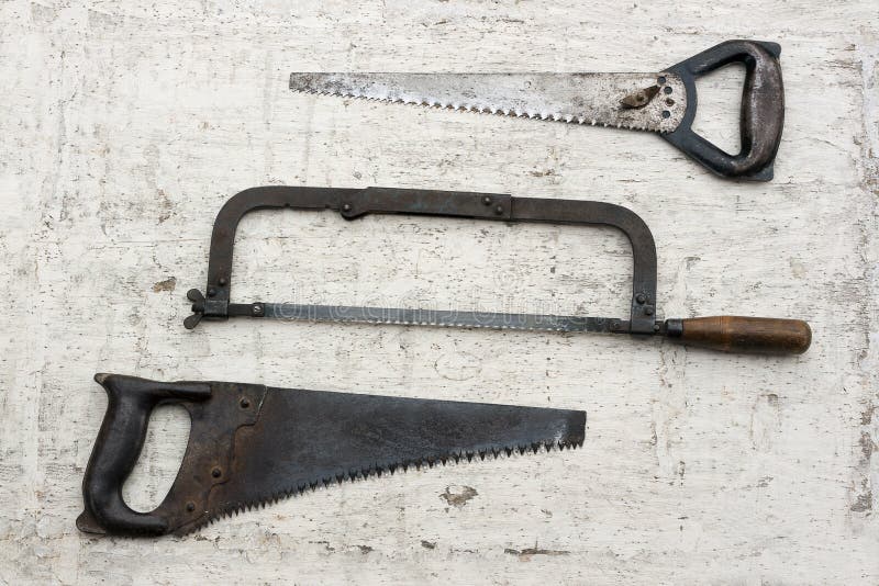 Three Different Used Retro Saws in White Rustic Wooden Background Stock ...