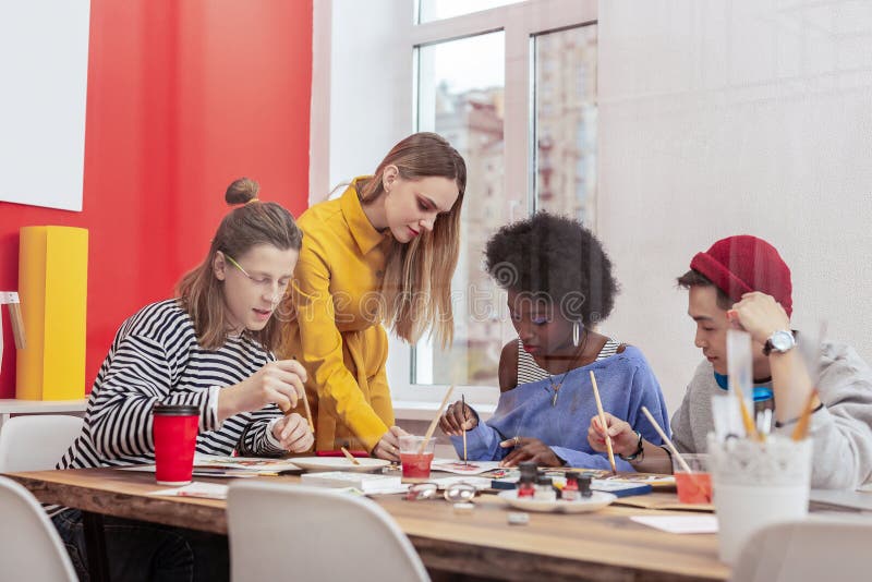 Three Diligent Students of Art Department Working Hard at the Class ...