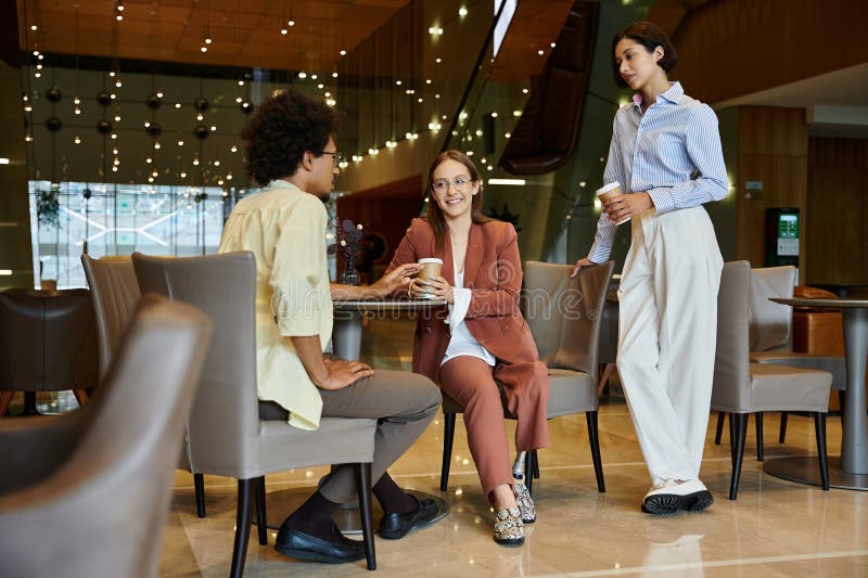 Three Diverse Colleagues Chat Over Coffee Stock Image - Image of ...
