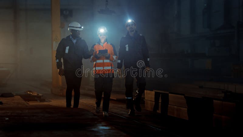 Three Diverse Multicultural Heavy Industry Engineers and Workers Walk ...