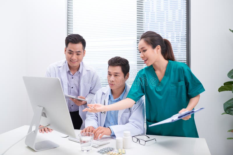 Three Doctors Discussing Patient Files on Office Stock Image - Image of ...