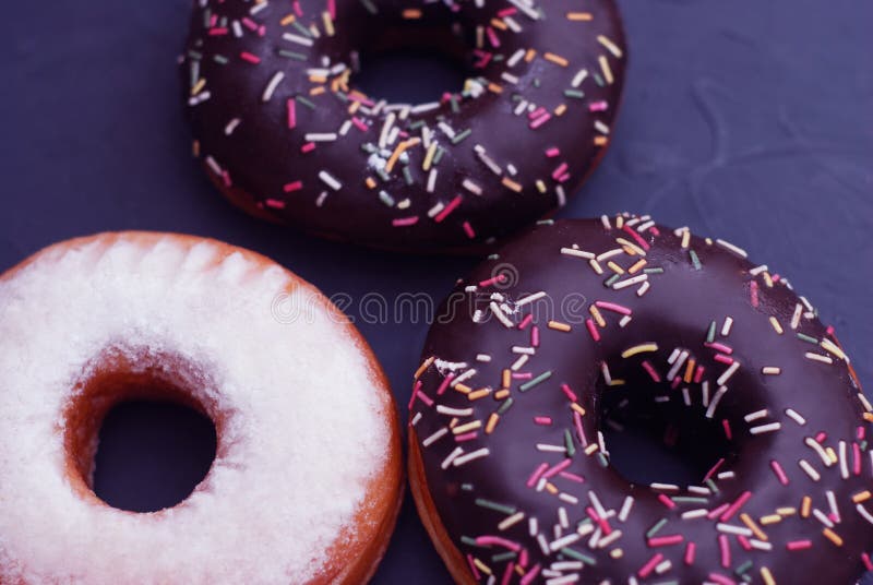 Three Donuts with Chocolate with Black Table. Sweet Breakfast. Stock ...