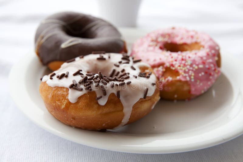 Three Donuts on a Plate stock photo. Image of sprinkles - 158283870