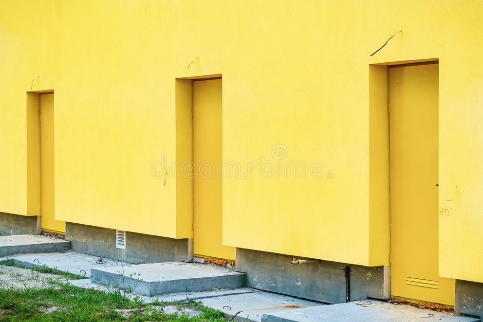 Three Doors on the Yellow Wall of the Building Stock Image - Image of ...