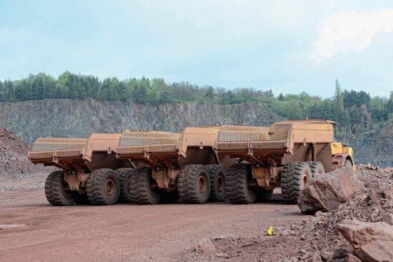 Three Dumper Trucks in a Row in a Quarry Mine. Stock Image - Image of ...