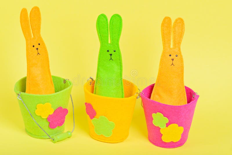 Three Easter Bunnies in Buckets on Yellow Stock Photo - Image of ...