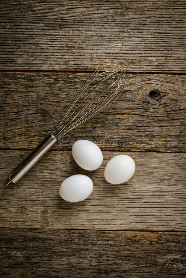 Three Eggs and Whisk stock photo. Image of cream, stainless - 47666876