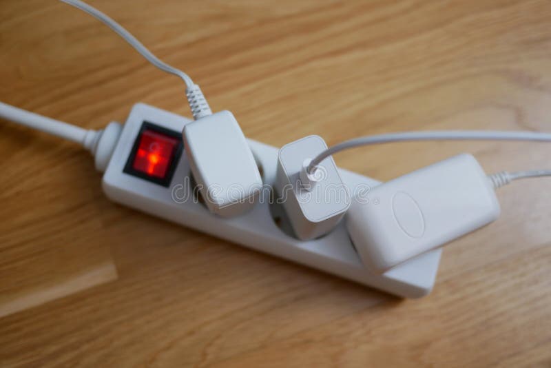 Three Electric Cables are Plugged into a Power Strip Socket Extension ...
