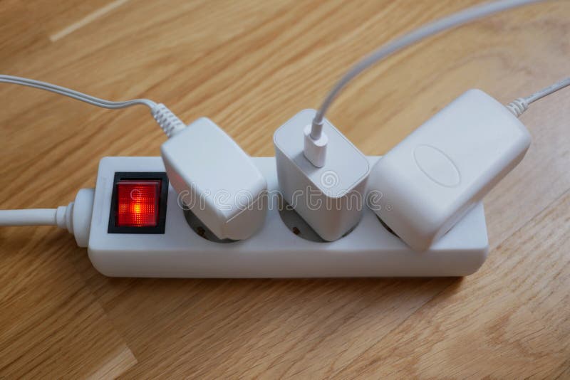 Three Electric Cables are Plugged into a Power Strip Socket Extension ...