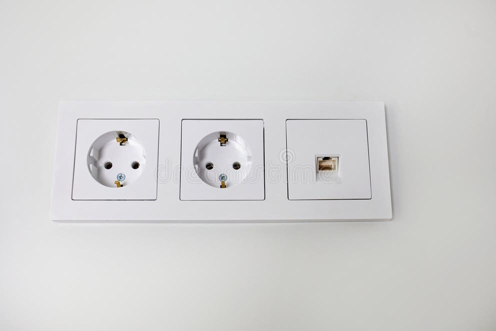 Three Electrical Outlets and a Network Connection Neatly Arranged on a ...