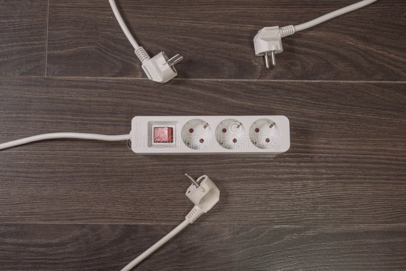 Three Electrical Plugs on the Floor Next To the Socket. Power Outage ...