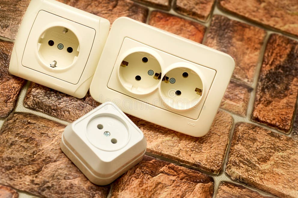 Three Electrical Sockets for Connecting Devices on Brick Wall Stock ...