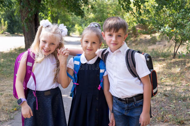 Three Elementary School Students with Backpacks Stock Photo - Image of ...