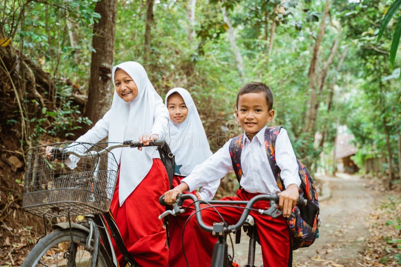 Three Elementary Students in Uniform Riding Their Bike Stock Image ...