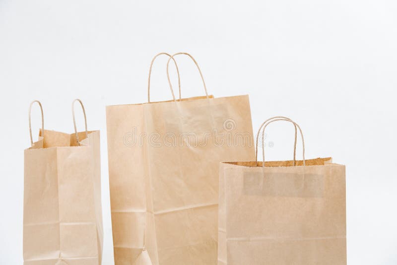 Three Empty Brown Paper Bags Arranged in a Composition Over White ...