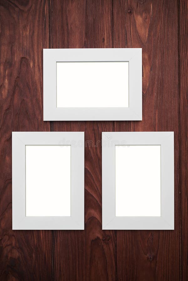Three Empty Frames in the Middle on Brown Wooden Desk Stock Photo ...