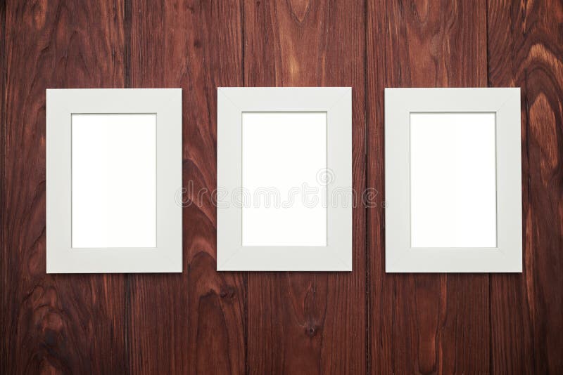 Three Empty Frames in the Middle on Brown Wooden Desk Stock Photo ...
