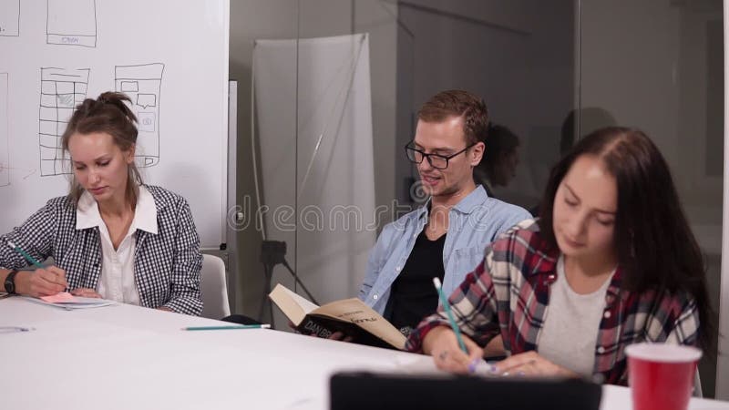 Three Entrepreneurs or Students Sitting Together Working in an Office ...