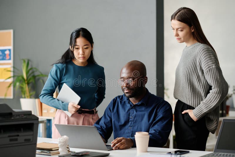 Three Ethnically Diverse Colleagues Working in Office Stock Photo ...
