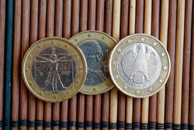 Three Euro Coins Lie on Wooden Bamboo Table in a Row Denomination is 2 ...