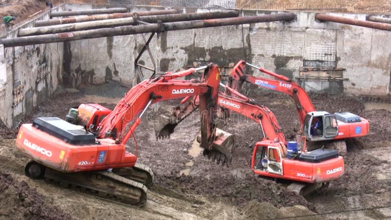Three Excavators Digging Foundation Pit for Stock Video - Video of ...