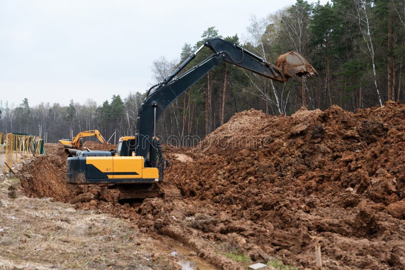 Three Excavators in the Process of Work Digs Stock Image - Image of ...