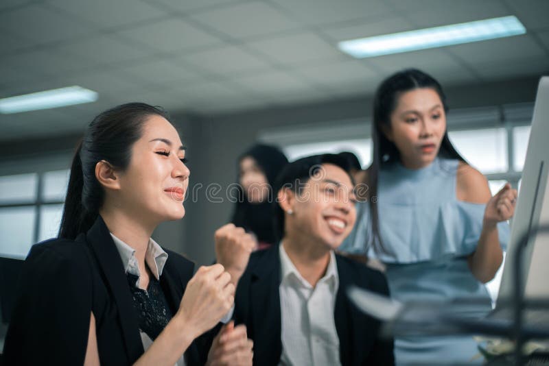 Three Excited Employees Reading Good News on Line in a Computer Desktop ...