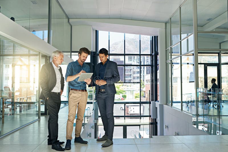 Three Eyes on the Project. Three Colleagues Talking Together Over a ...