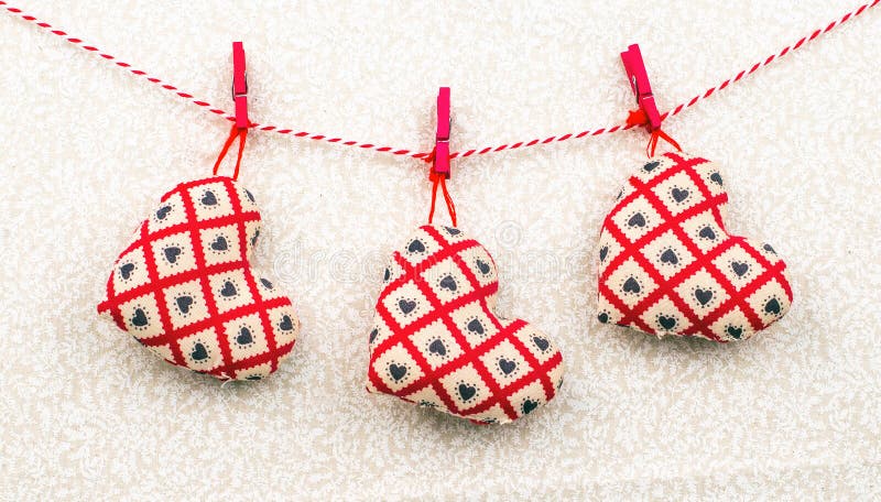 Three Fabric Hearts Hung on Red Striped String Stock Image - Image of ...