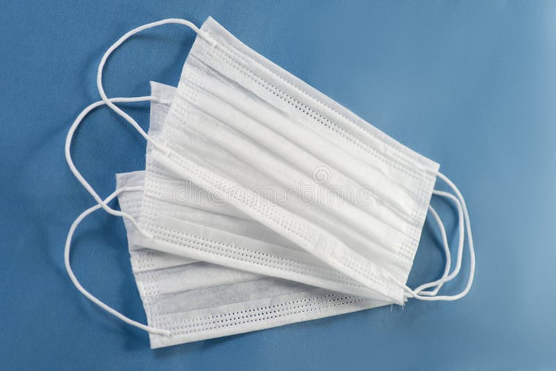 Three Face Masks on a Blue Background Stock Image - Image of disposable ...