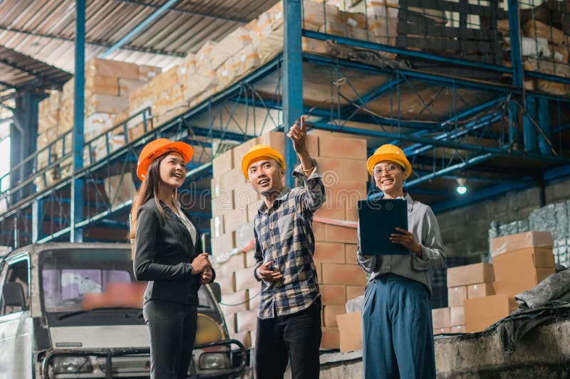 Three Factory Employees Stand at Work Looking of the Factory S Storage ...