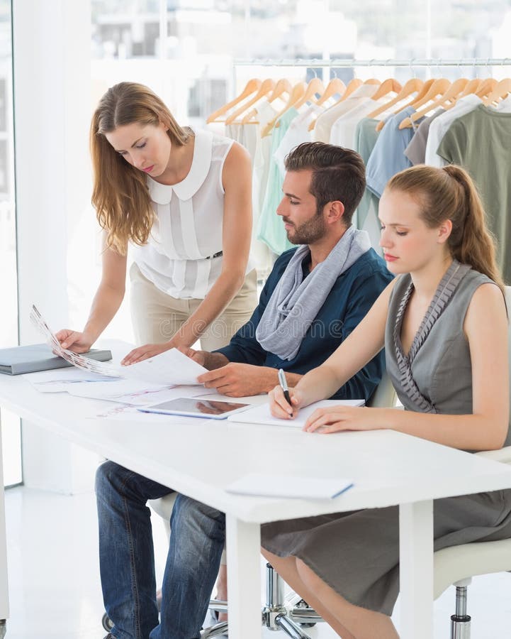 Three Fashion Designers Discussing Designs Stock Image - Image of side ...