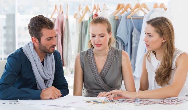 Three Fashion Designers Discussing Designs Stock Image - Image of young ...