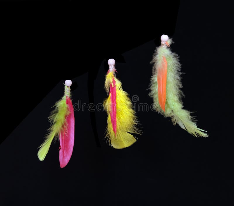 Three Feathers Soaring on a Black Background Stock Image - Image of ...