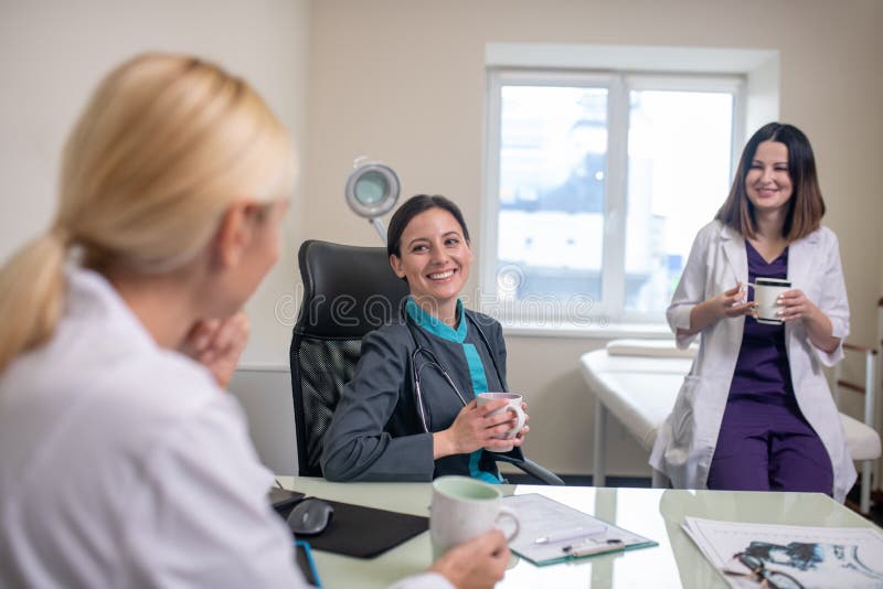 Three Female Doctors Feeling Good at Work Place Stock Image - Image of ...
