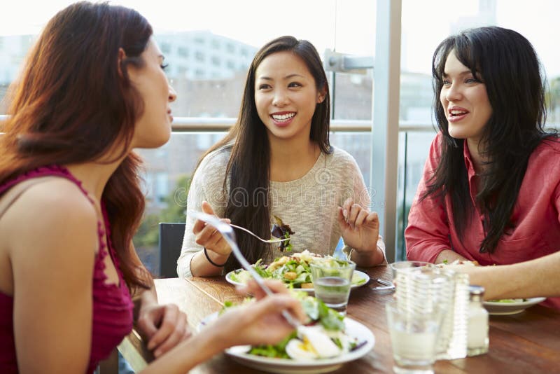 Three Female Friends Enjoying Lunch at Rooftop Restaurant Stock Image ...