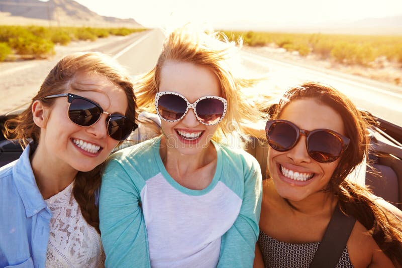 Three Female Friends on Road Trip in Back of Convertible Car Stock ...